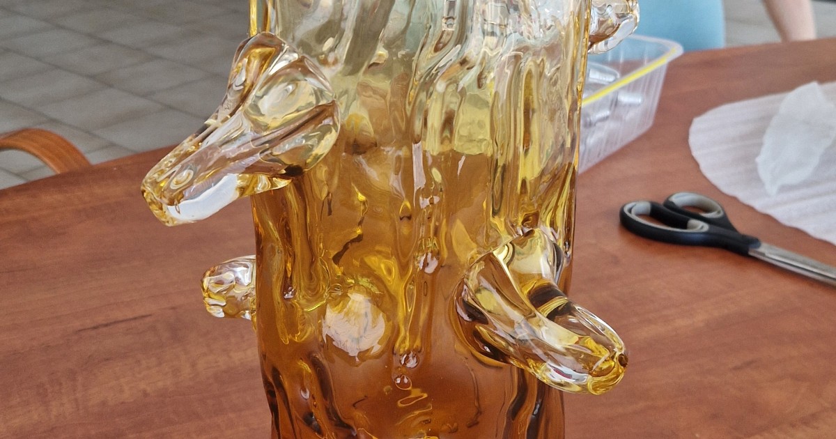 Glass chandeliers imitating cut parts of the trunk of a coniferous ...